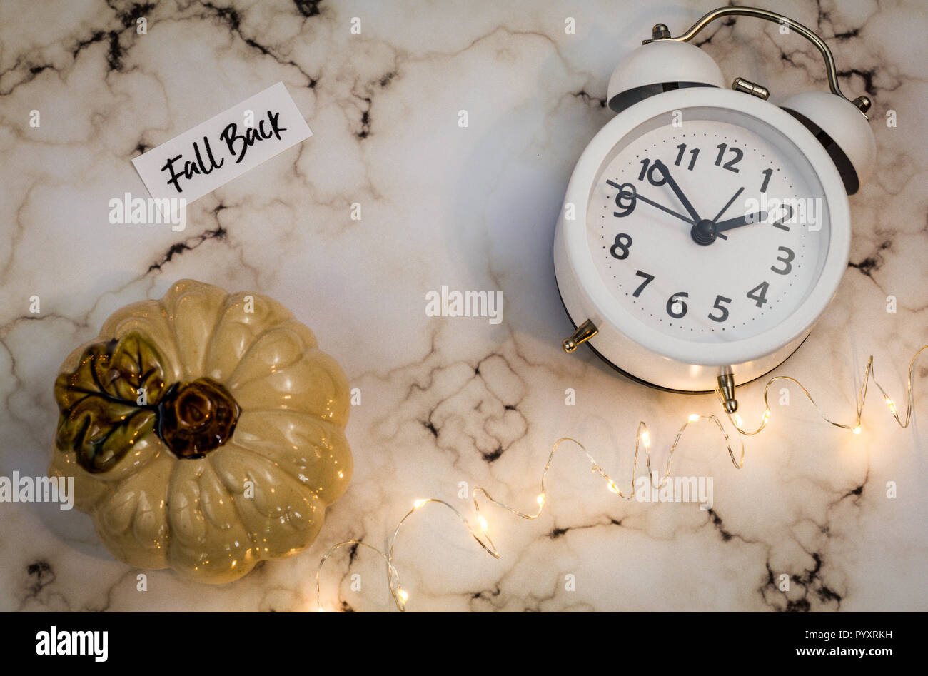 Fall Back Daylight Saving Time concept with white clock and autumn ...