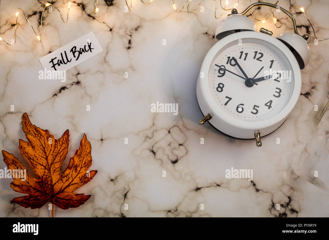 Fall Back Daylight Saving Time concept with white clock and autumn ...