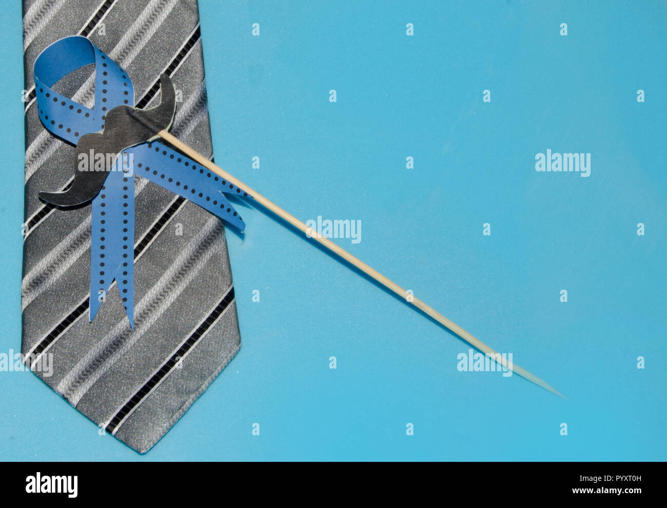 Blue ribbon and neck tie on blue background. Blue november concept ...