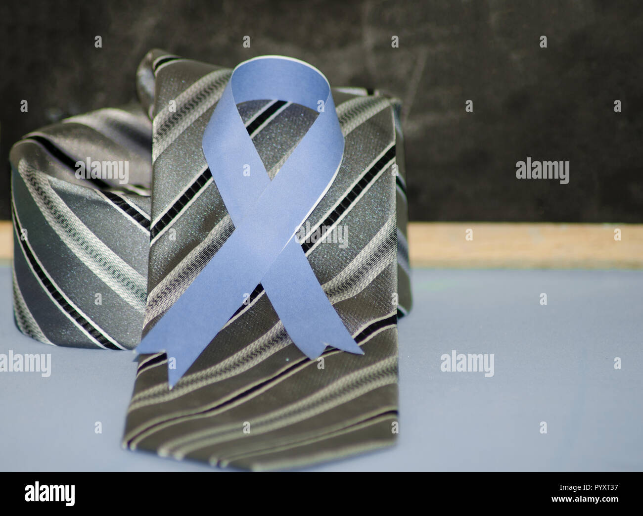 Blue ribbon and neck tie on blue background. Blue november concept ...