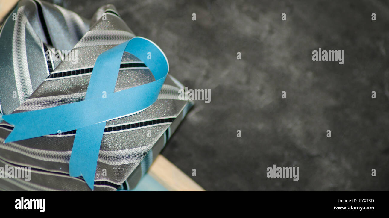 Blue ribbon and neck tie on blue background. Blue november concept ...