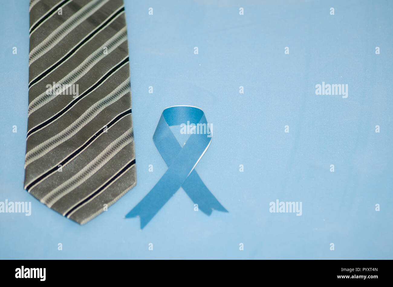 Blue ribbon and neck tie on blue background. Blue november concept ...