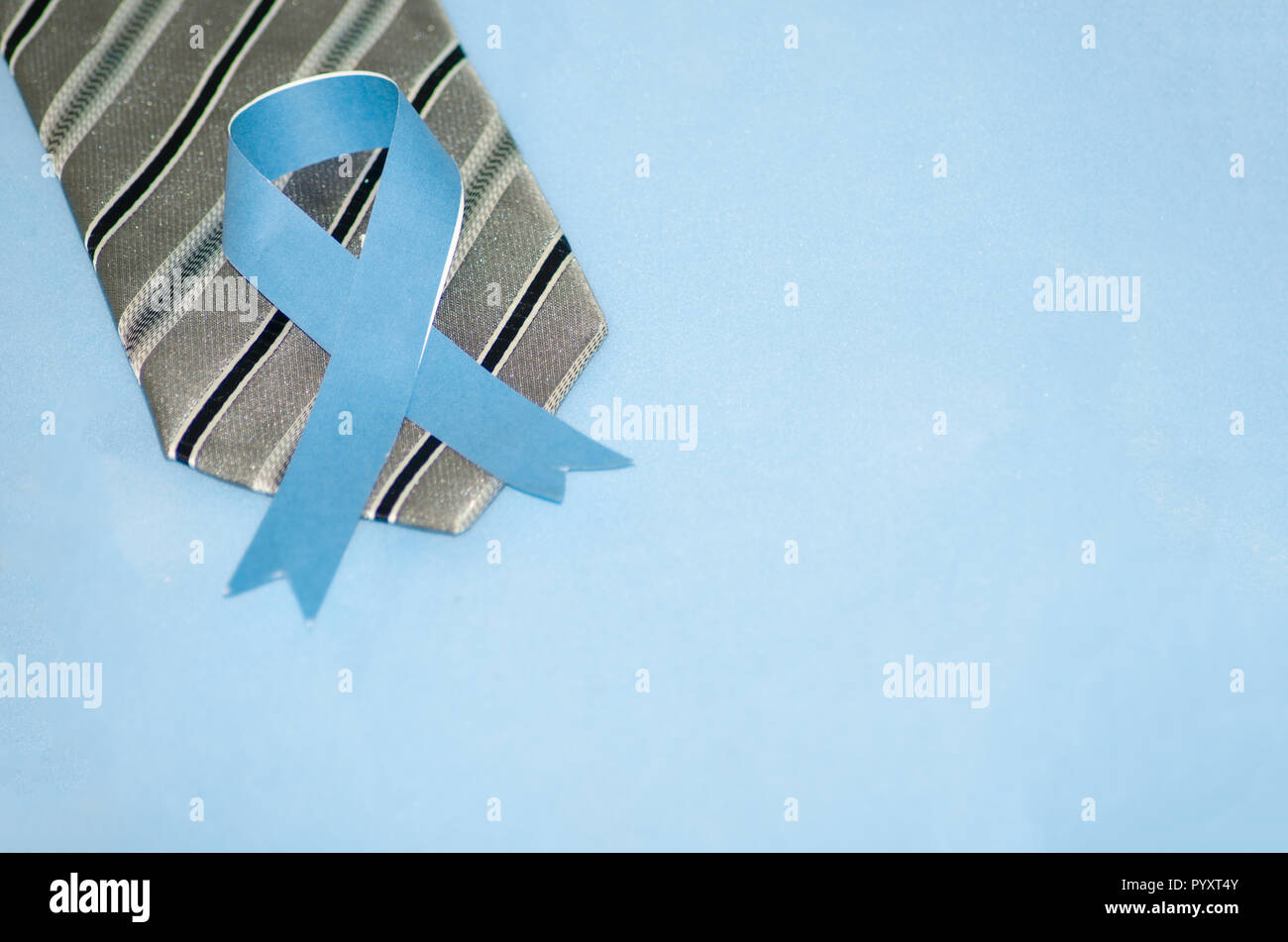Blue ribbon and neck tie on blue background. Blue november concept ...