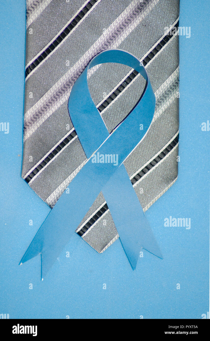 Blue ribbon and neck tie on blue background. Blue november concept ...