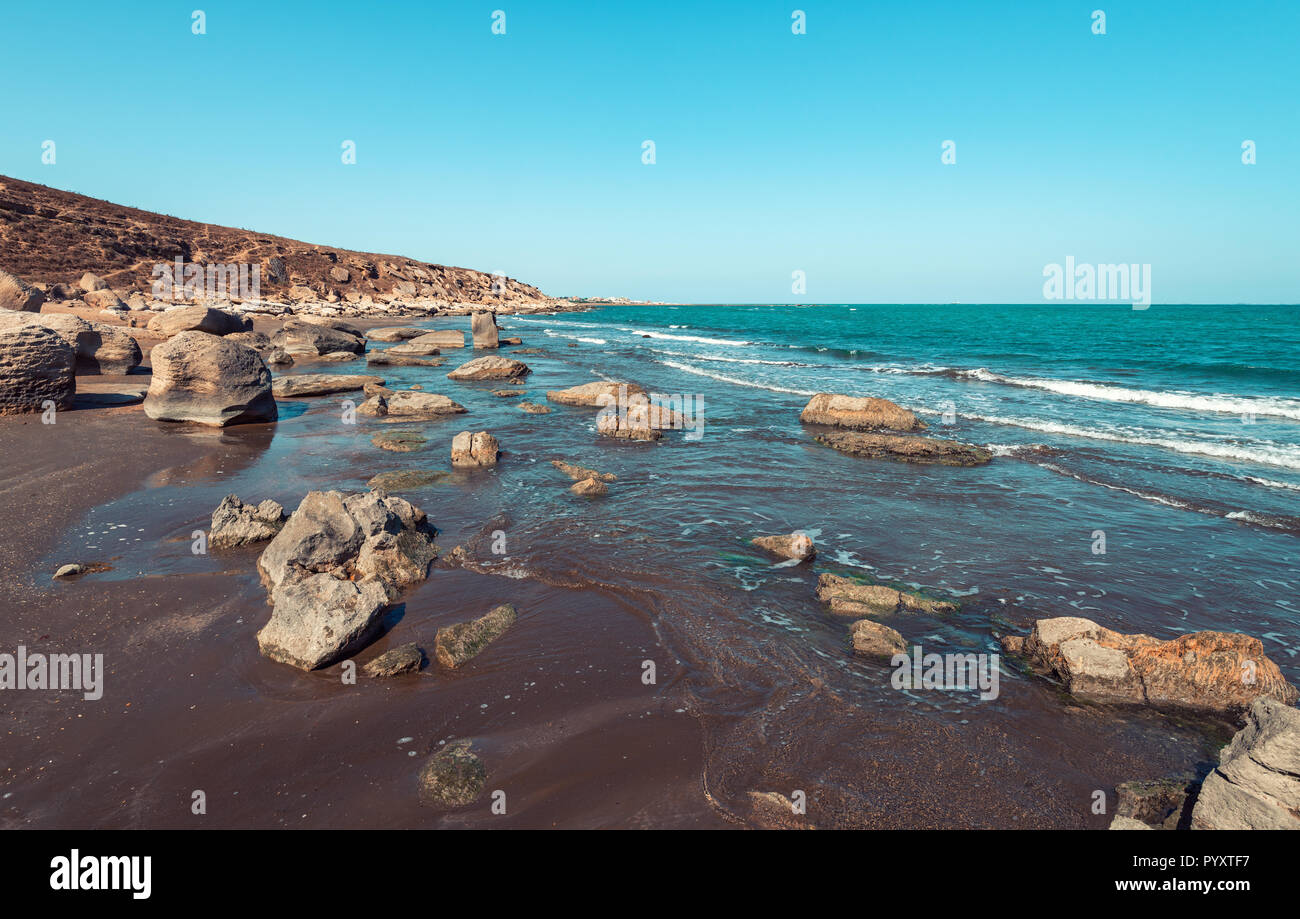 Rocky sea coast with turquoise water on the beach Stock Photo - Alamy