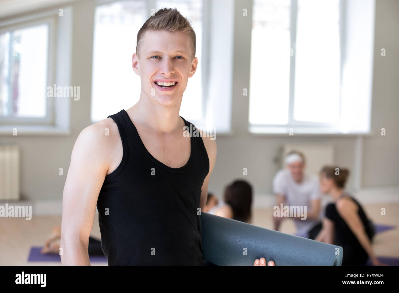 Handsome friendly trainer instructor smiling looking at camera Stock ...