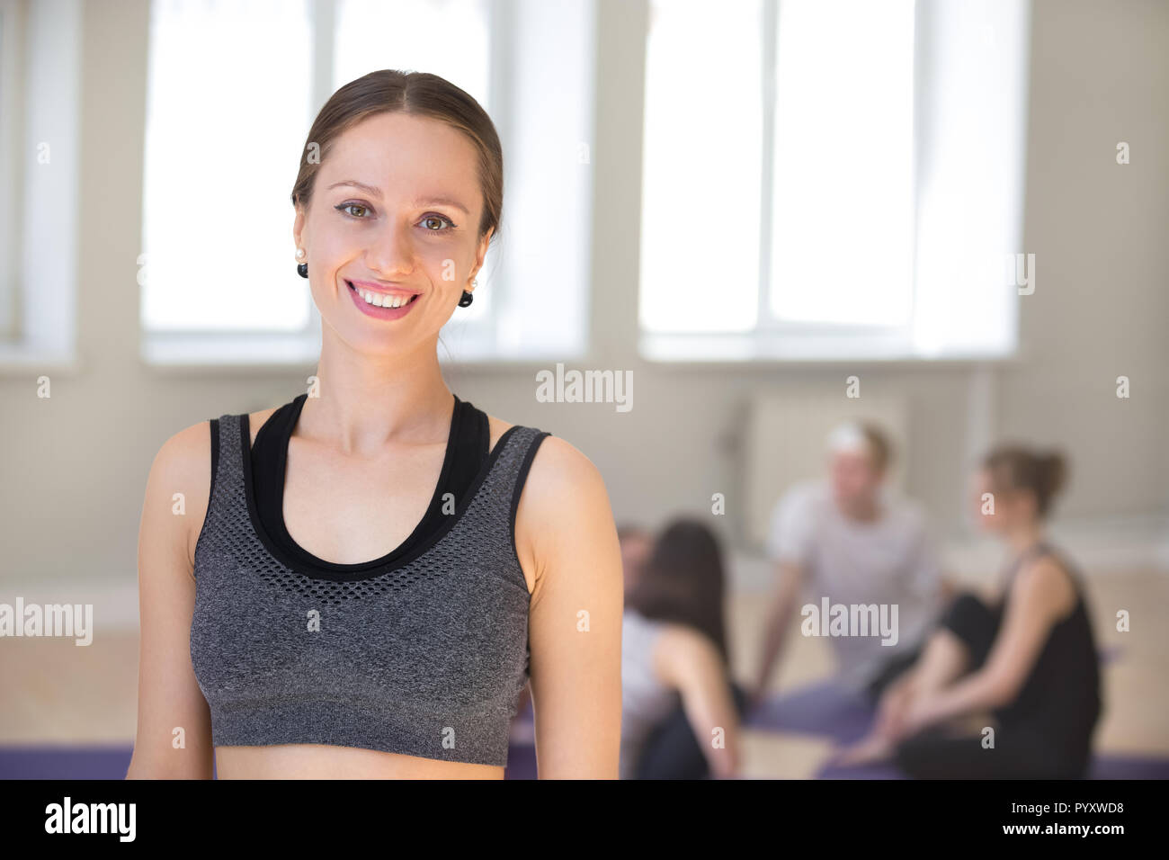 Beautiful yoga instructor smiling looking at camera Stock Photo - Alamy