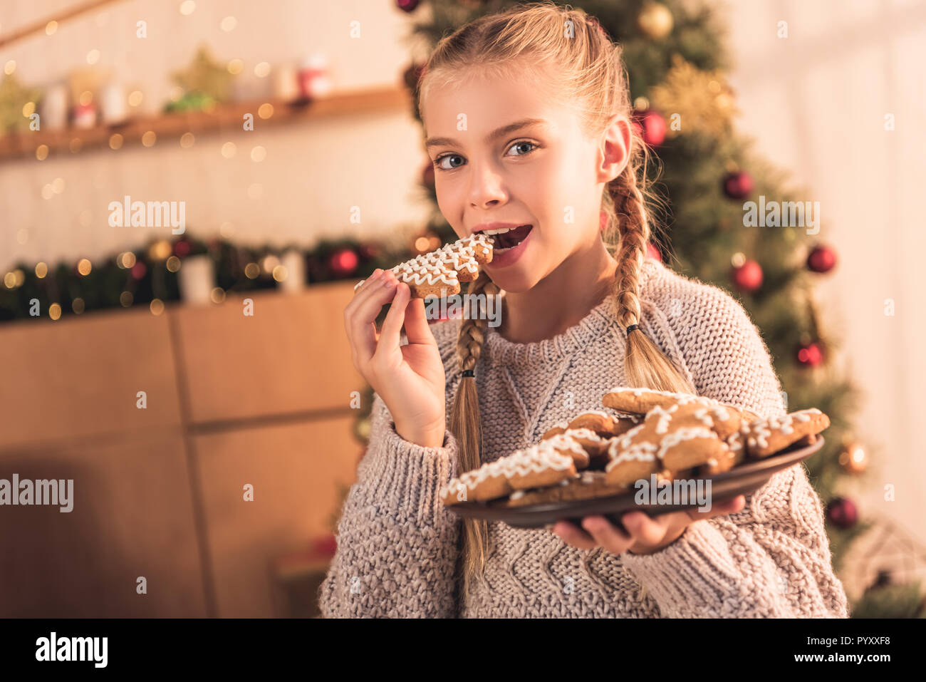 happy kid eating traditional christmas gingerbread cookie Stock Photo ...