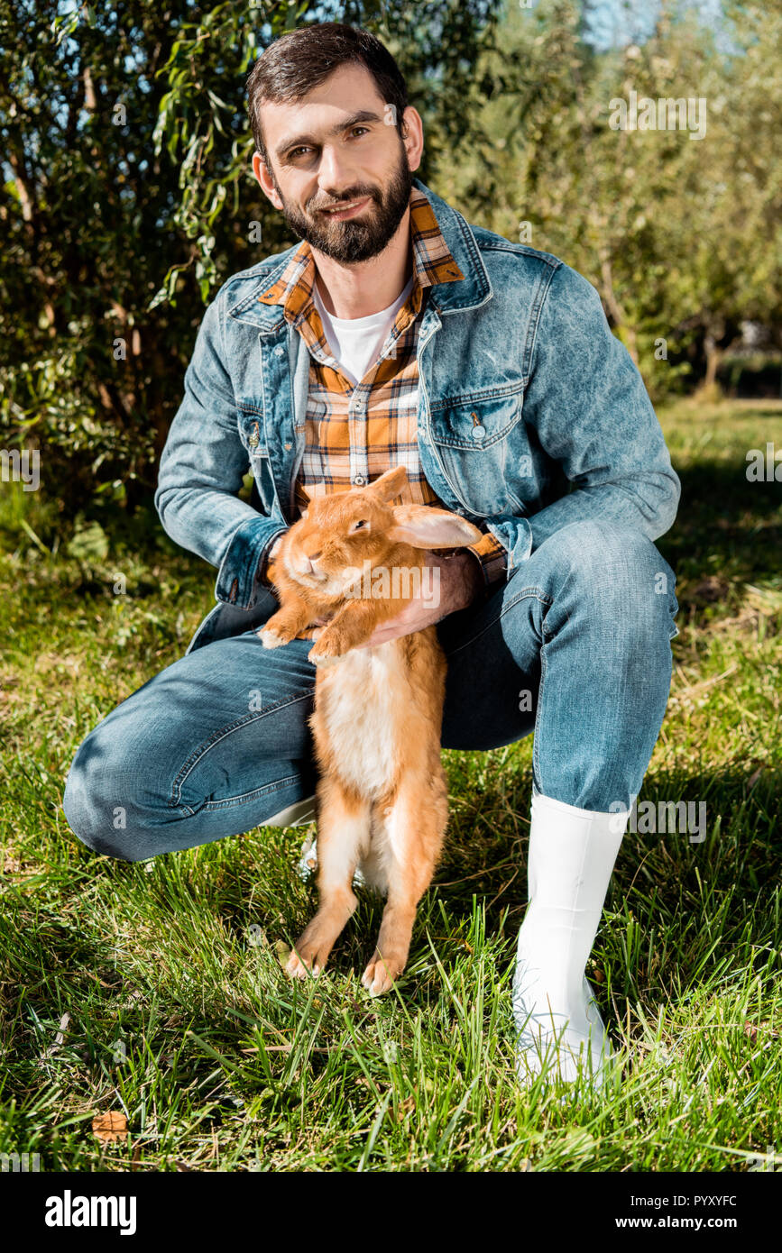 Man holding rabbit outdoors hi-res stock photography and images - Alamy