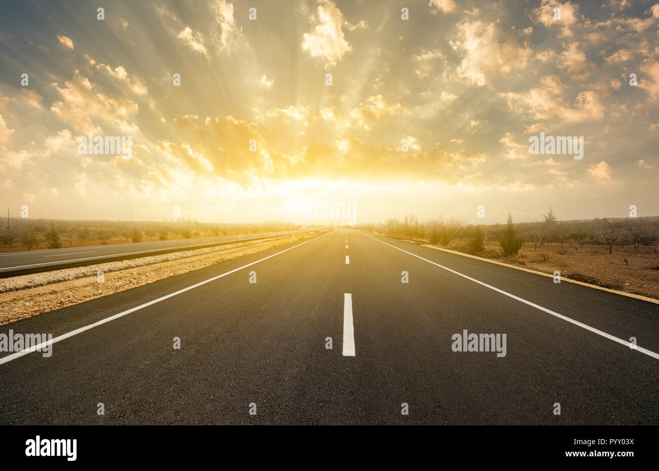 Dramatic sunrise on asphalt road Stock Photo - Alamy