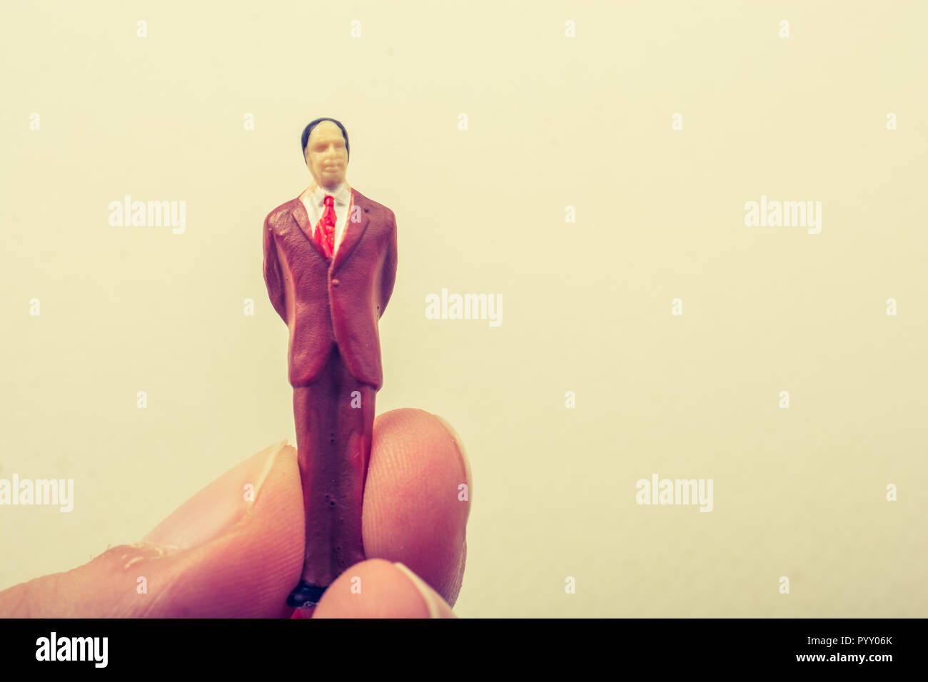Tiny figurine of man miniature model in hand Stock Photo - Alamy