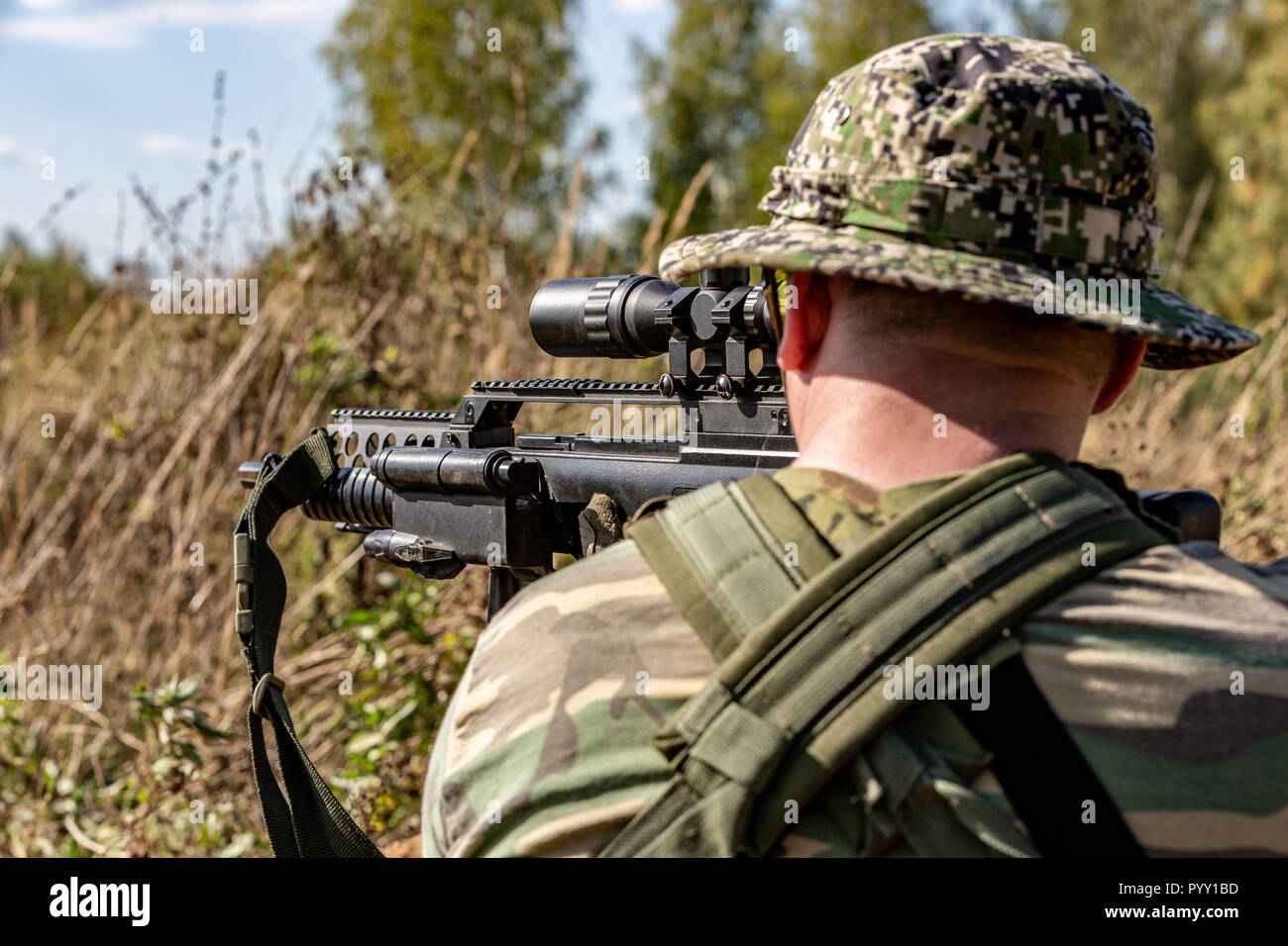 special forces soldier. assault rifle with silencer and optical sight ...