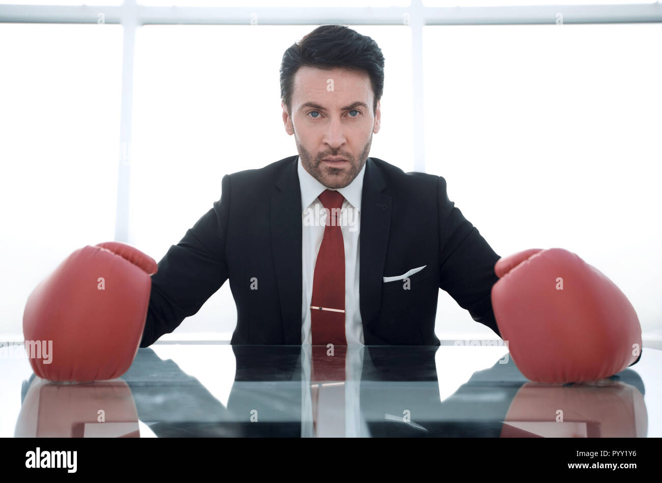 businessman in Boxing gloves sitting at the office Desk Stock Photo - Alamy
