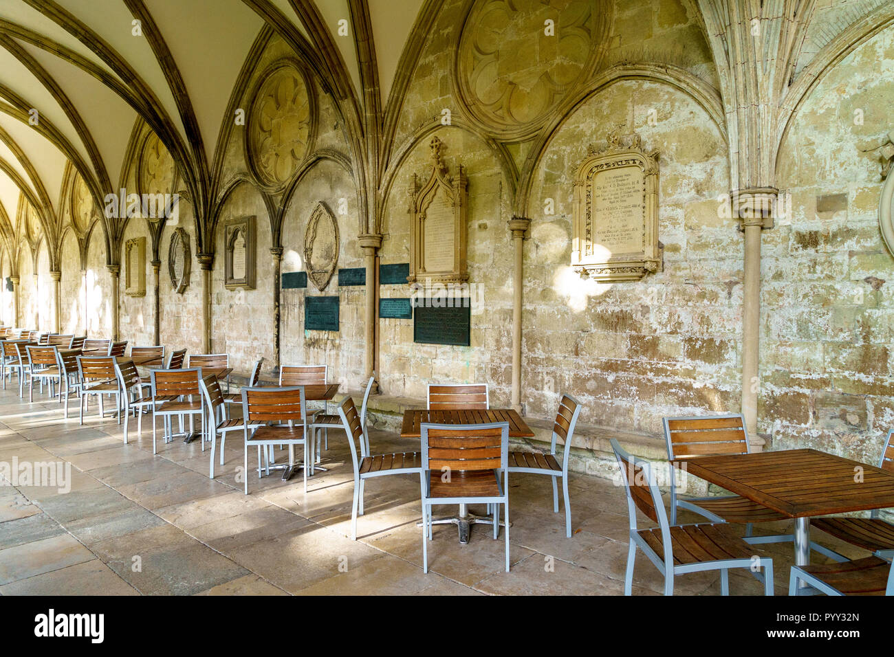Row of empty tables and chairs in Salisbury Cathedral cloisters Stock ...
