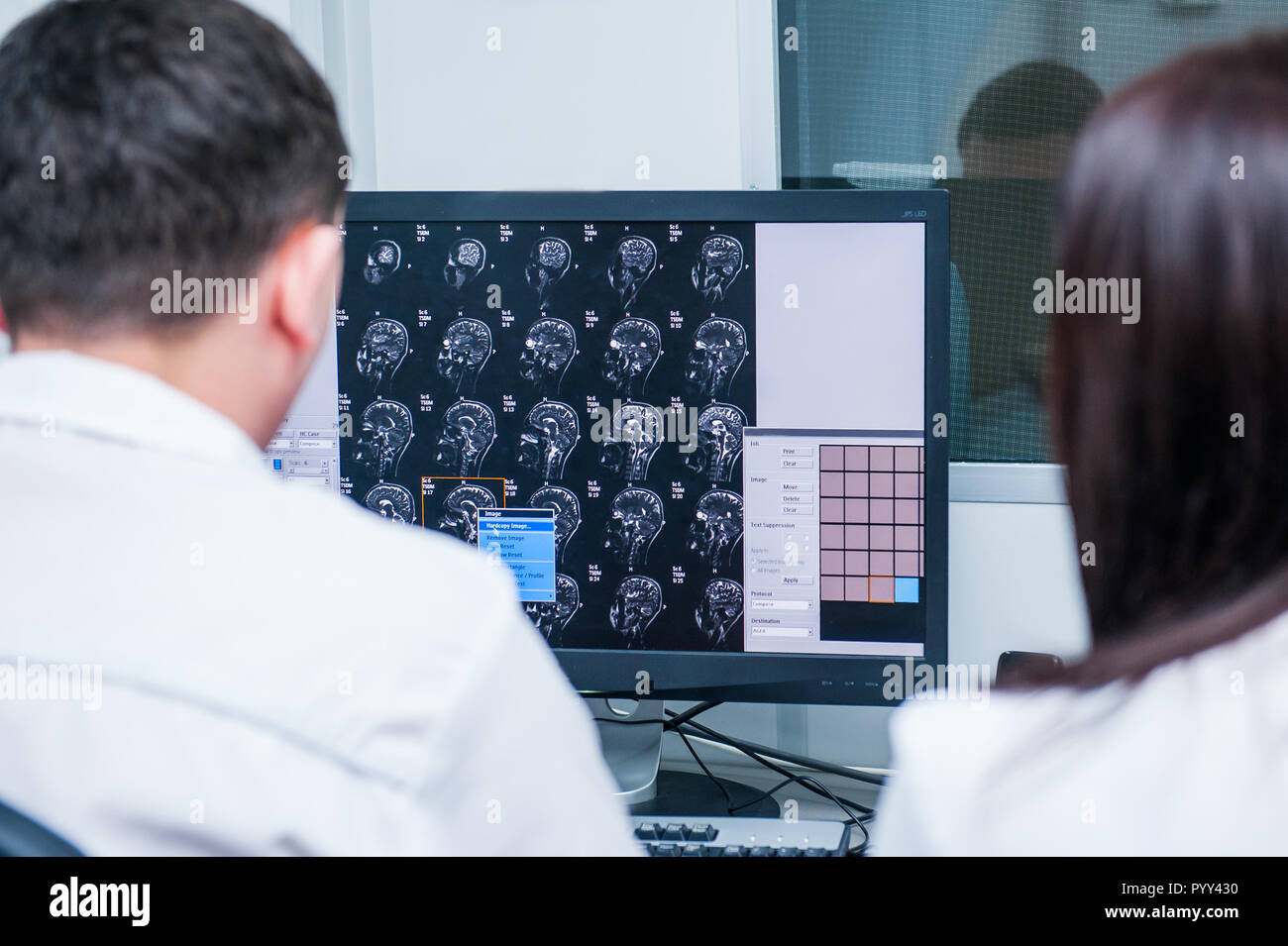 Doctors consider and discuss magnetic resonance image (MRI) of the ...
