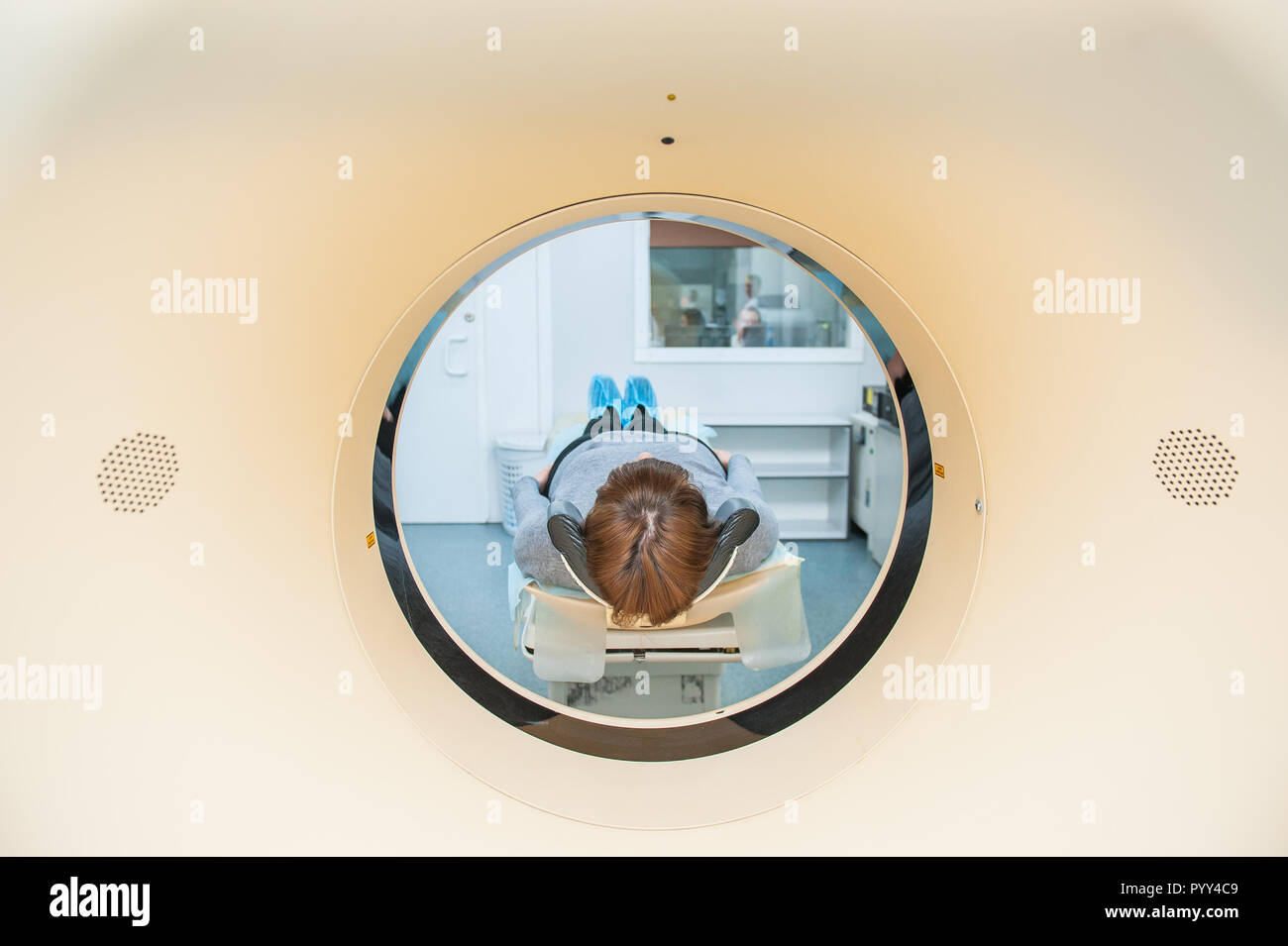 Close up patient at CT scan tomography in hospital, shot through the ...