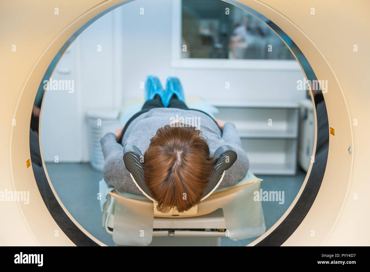 Close up patient at CT scan tomography in hospital, shot through the ...
