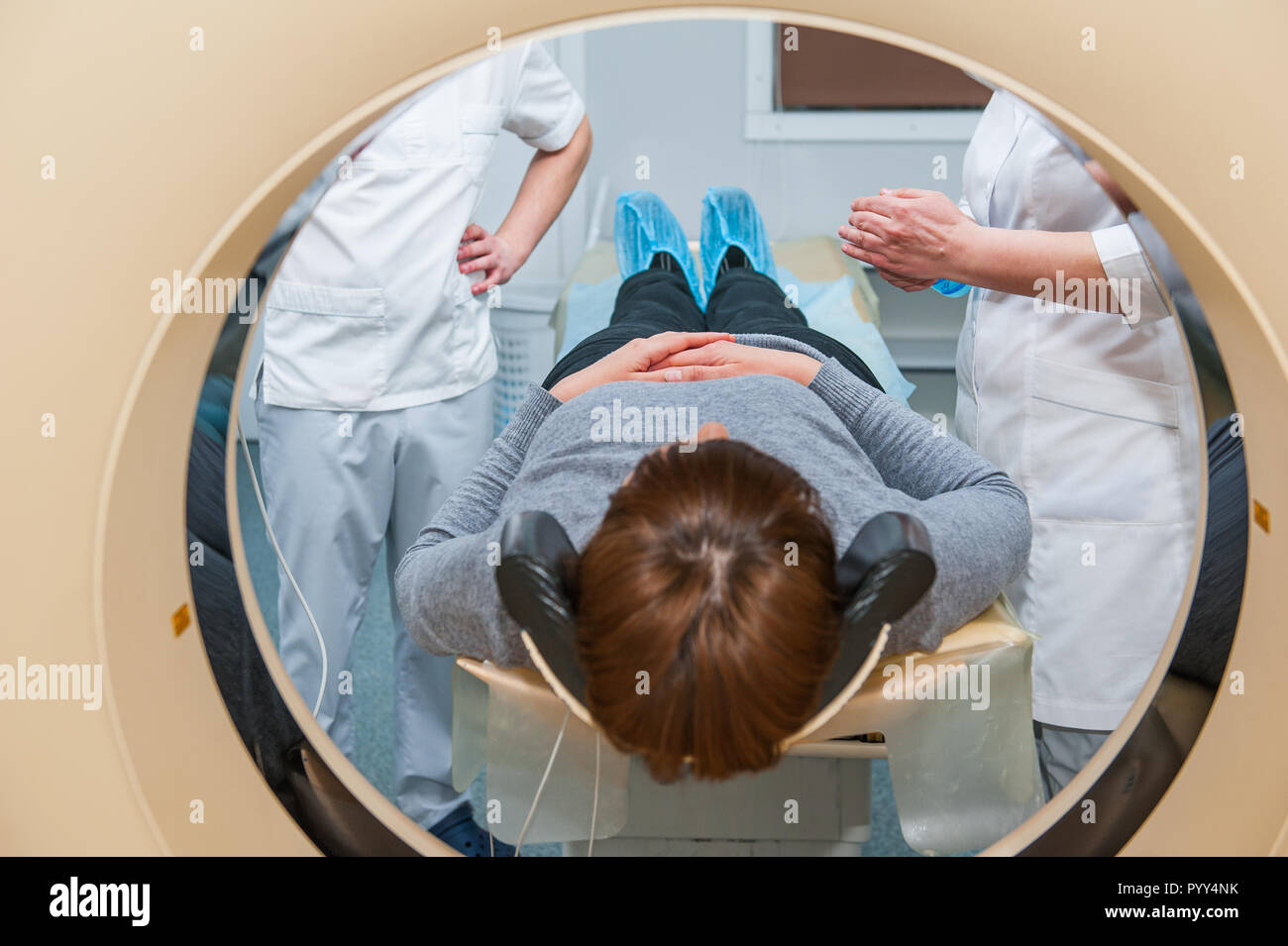 Doctor and assistant prepeared female patient for computed tomography ...