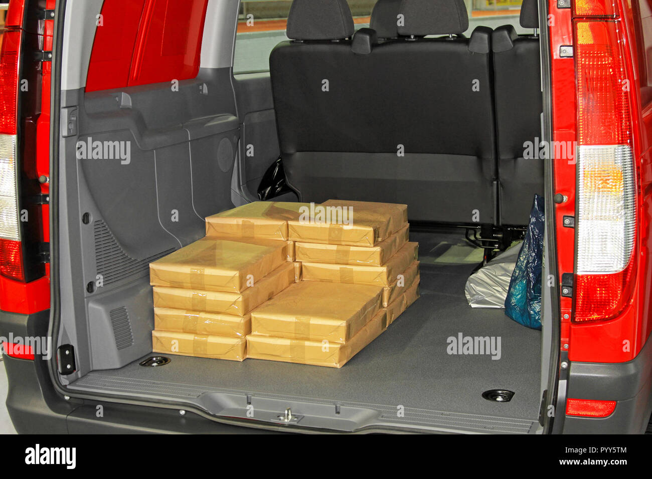 Bunch of boxes in mini van trunk Stock Photo - Alamy