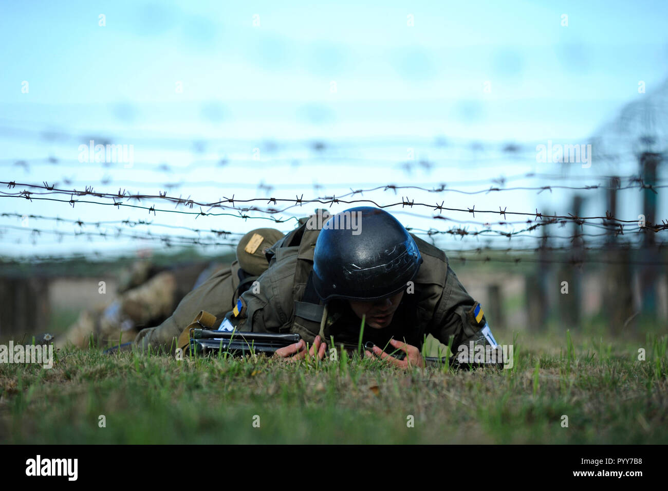 On a military training ground, exercises: Ukrainian soldier crawling ...