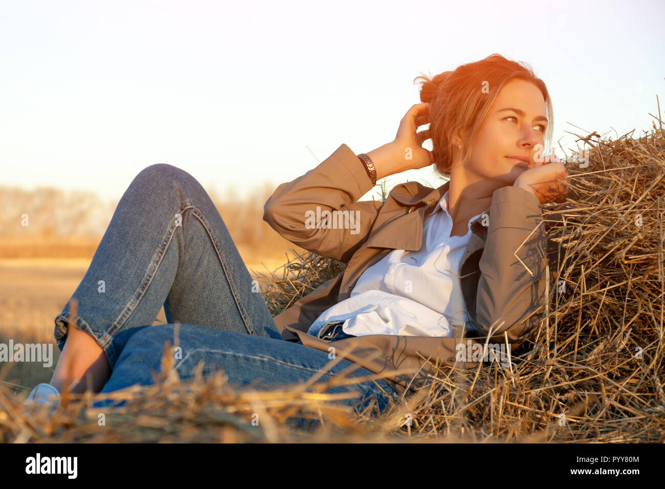 Girl lying on haystack hi-res stock photography and images - Alamy