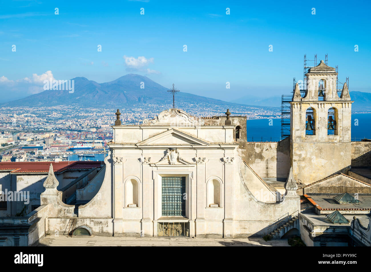 Bright skyline view of Naples, Italy with Mount Vesuvius standing above ...