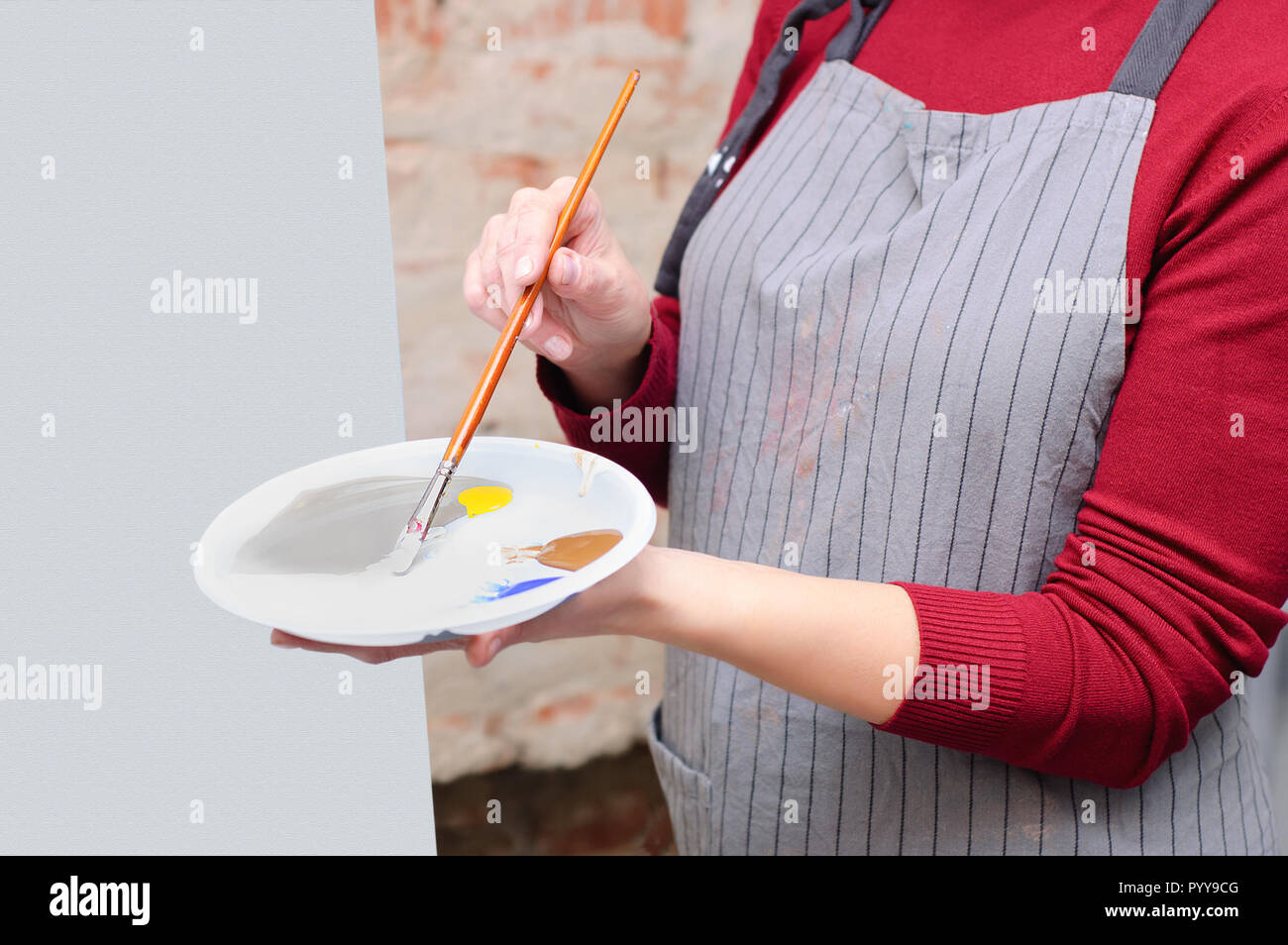 Girl with a palette of colors in her hands. In the Art workshop Stock ...