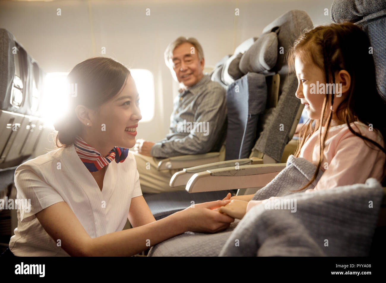 Flight attendants and passengers on the plane Stock Photo - Alamy