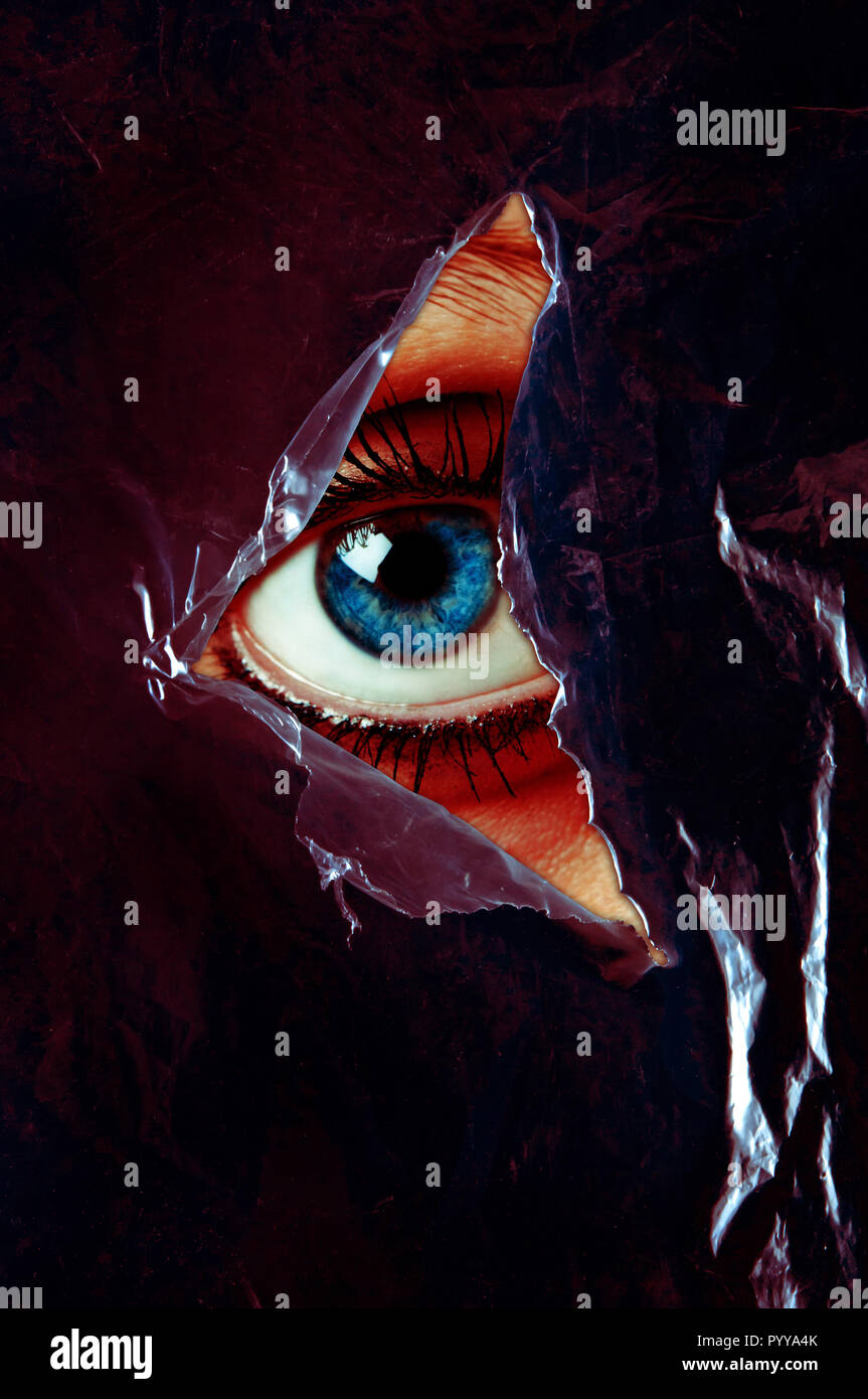 blue eye peeking behind a broken plastic sheet Stock Photo - Alamy