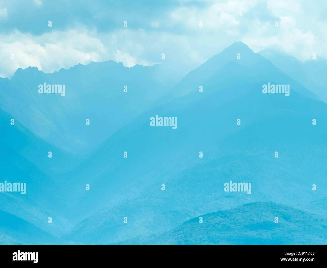 Blue Mountain Crests With Mist Landscape Stock Photo - Alamy