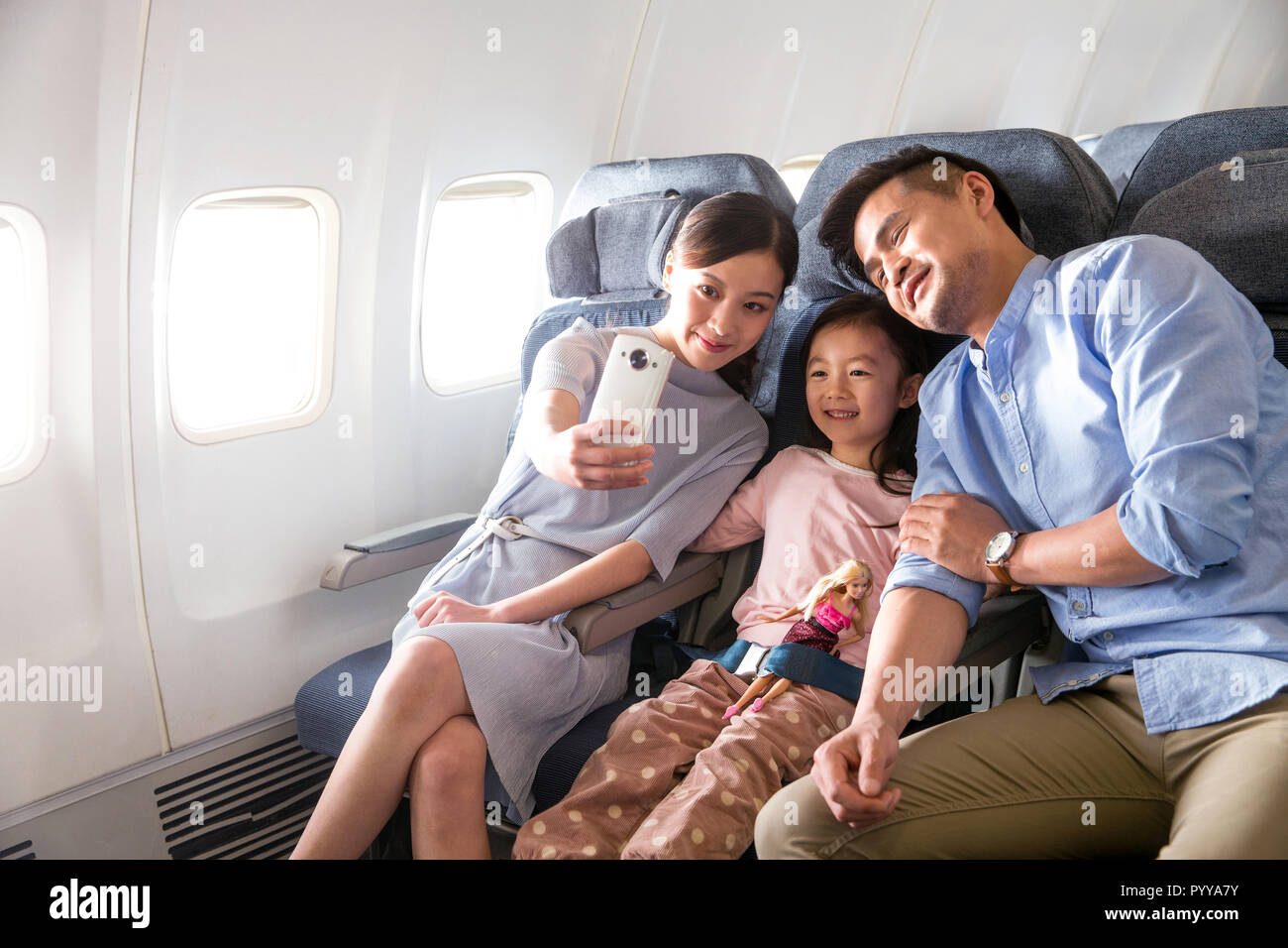 Happy families by plane Stock Photo - Alamy