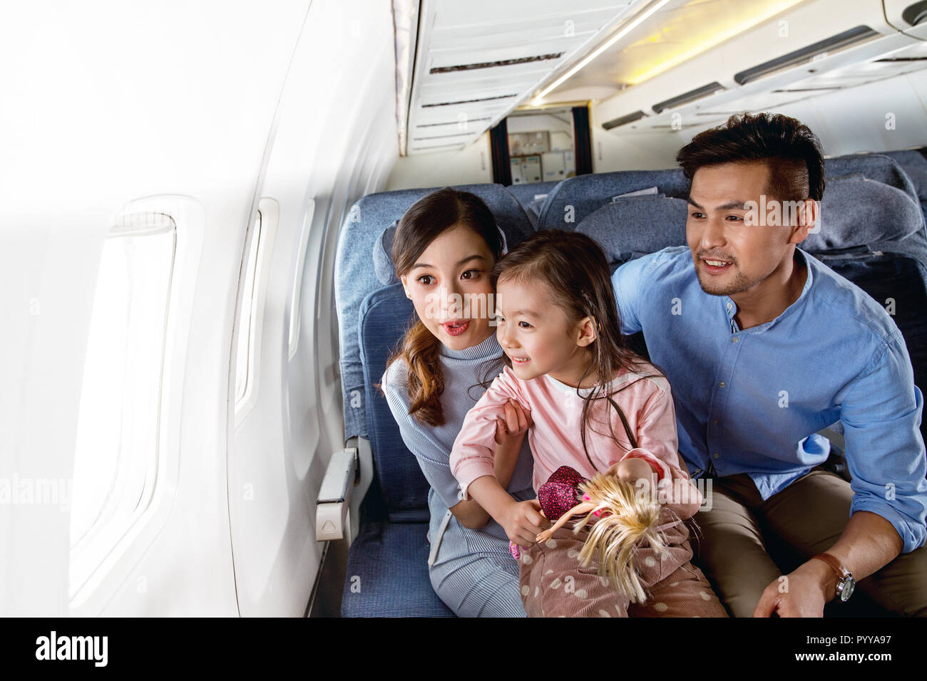 Happy families by plane Stock Photo - Alamy