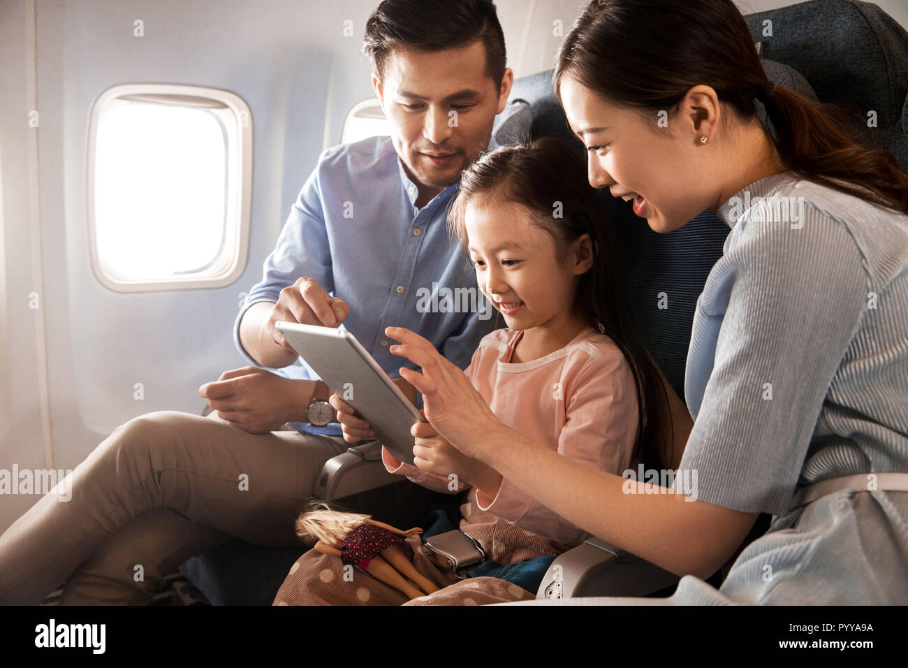 Happy families by plane Stock Photo - Alamy