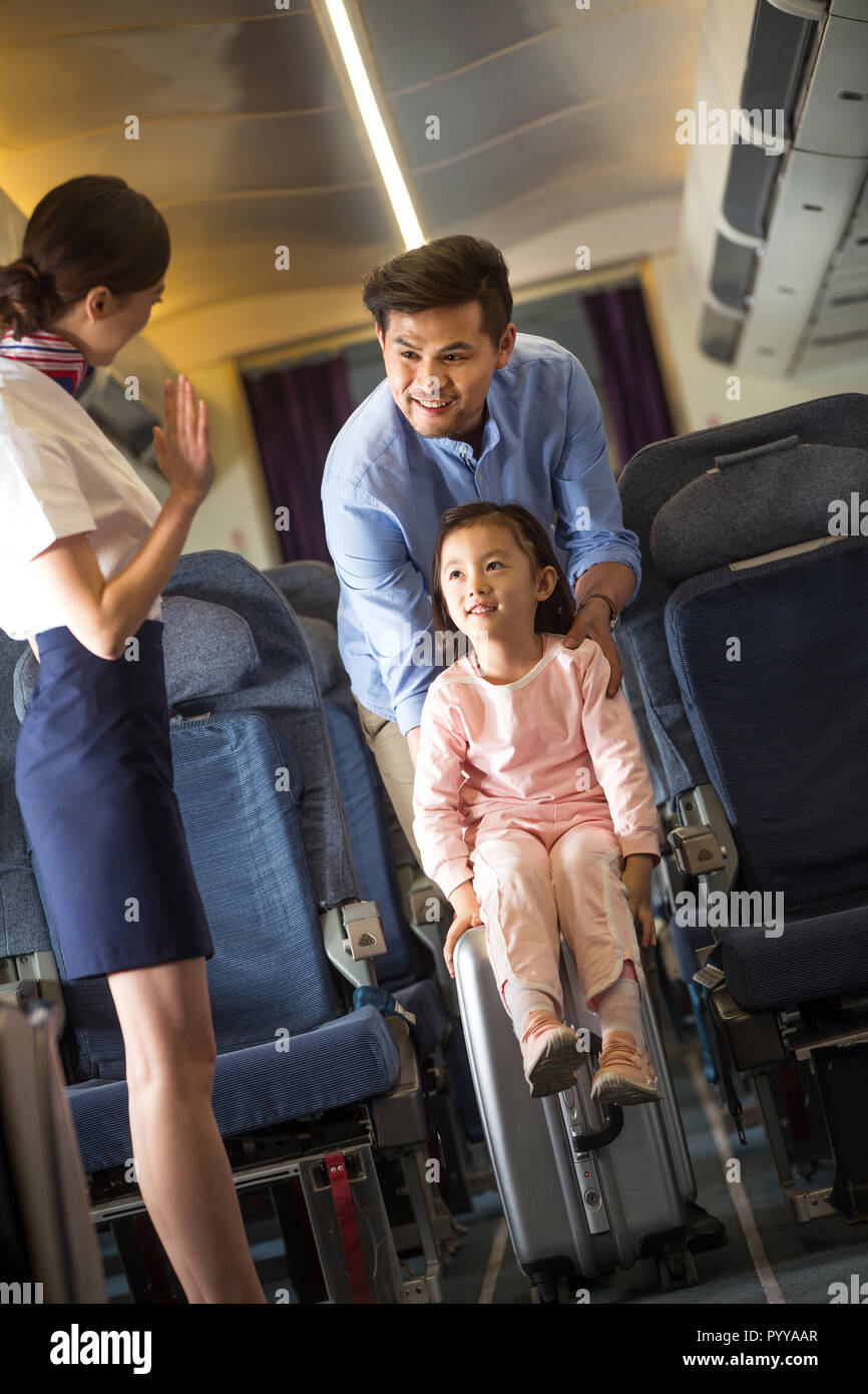 Flight attendants and passengers on the plane Stock Photo - Alamy