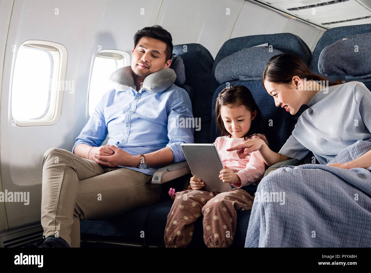 Happy families by plane Stock Photo - Alamy