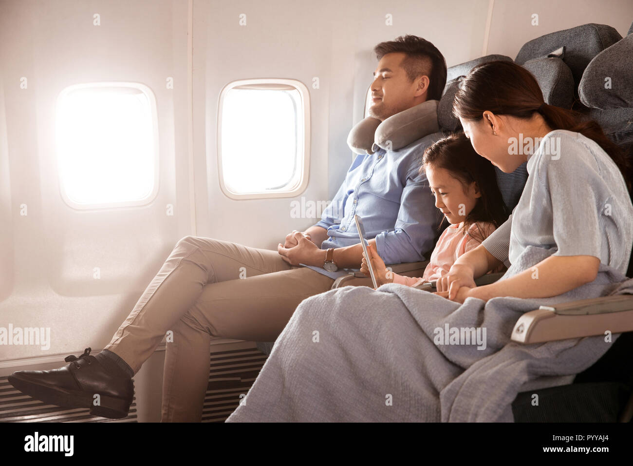Happy families by plane Stock Photo - Alamy