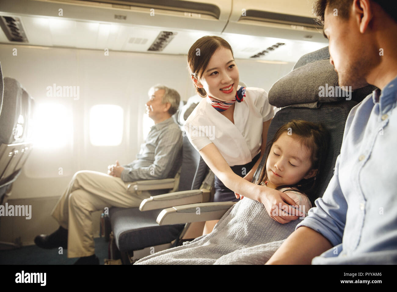 Flight attendants and passengers on the plane Stock Photo - Alamy