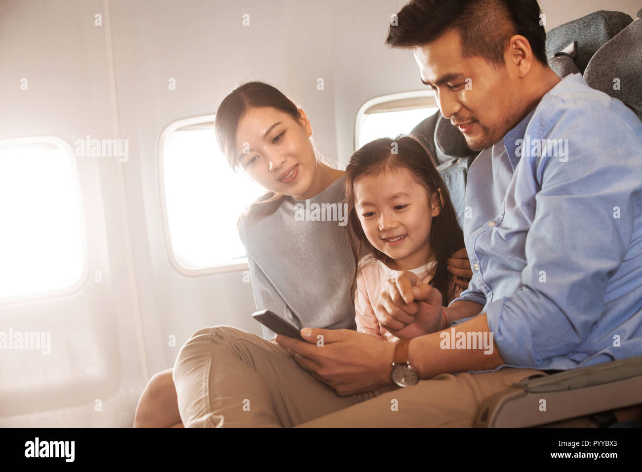 Happy families by plane Stock Photo - Alamy