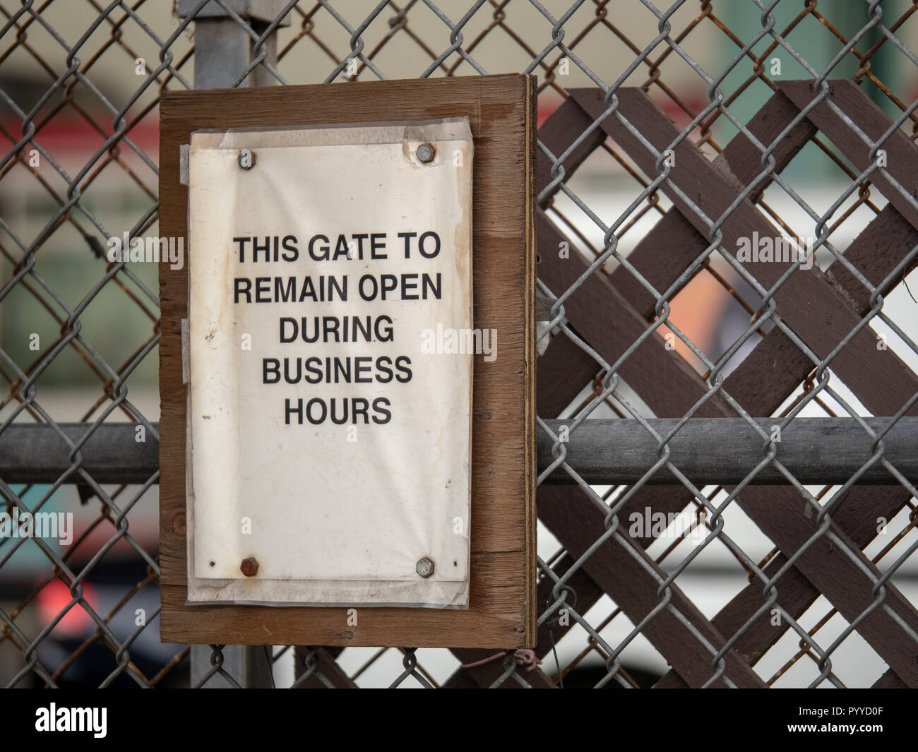 This gate to remain open during business hours paper sign on fence ...