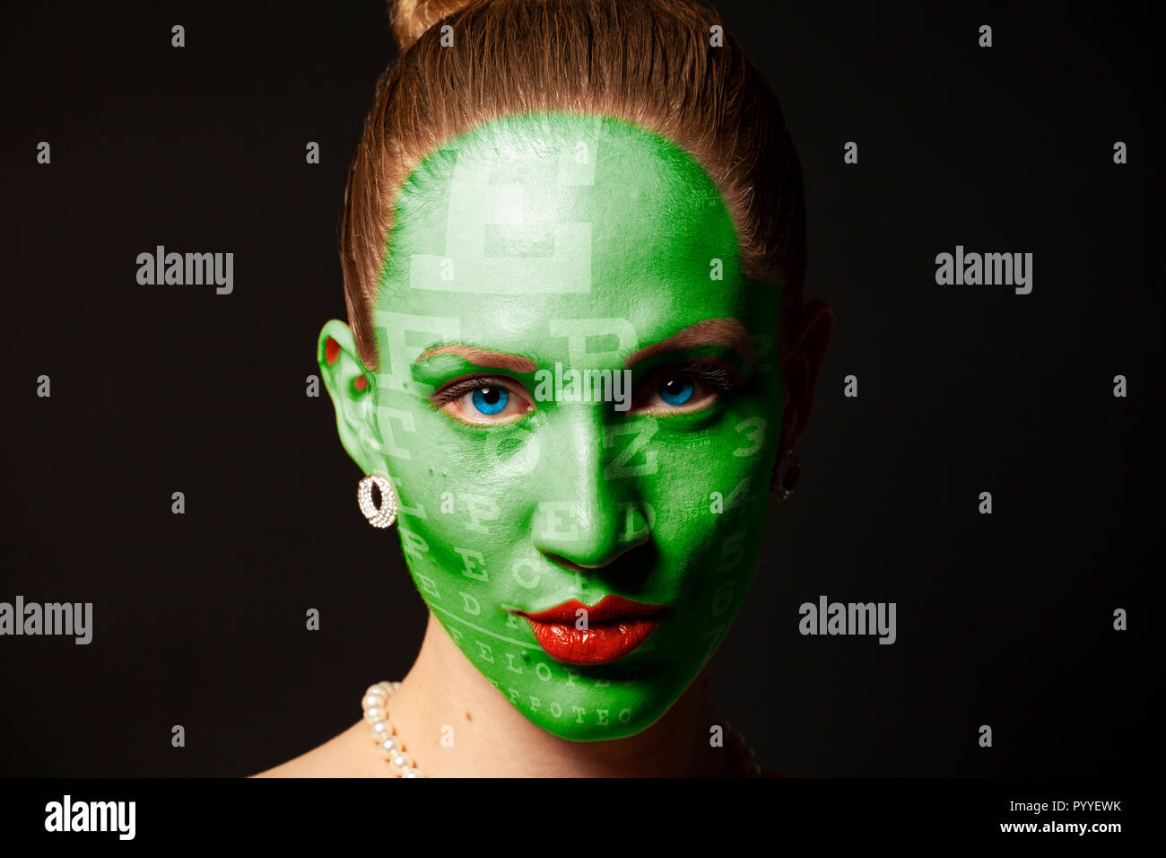 eyesight test chart on face young woman closeup Stock Photo - Alamy