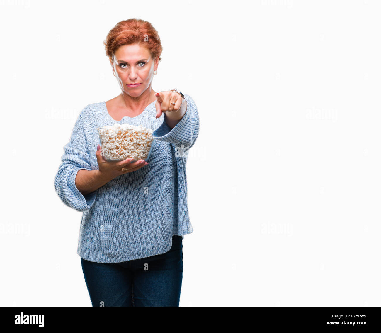 Atrractive Senior Caucasian Redhead Woman Eating Popcorn Over Isolated