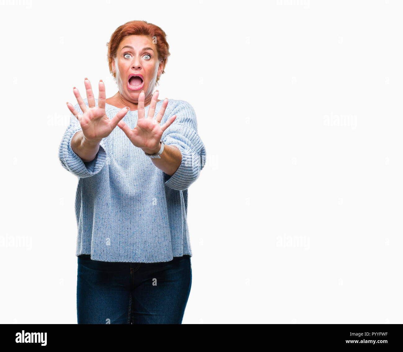 Atrractive senior caucasian redhead woman wearing winter sweater over ...