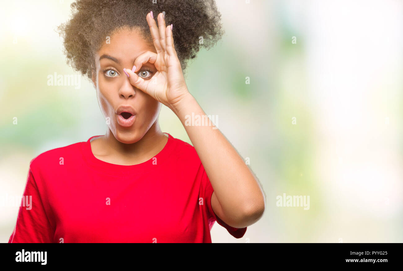 Young afro american woman over isolated background doing ok gesture ...