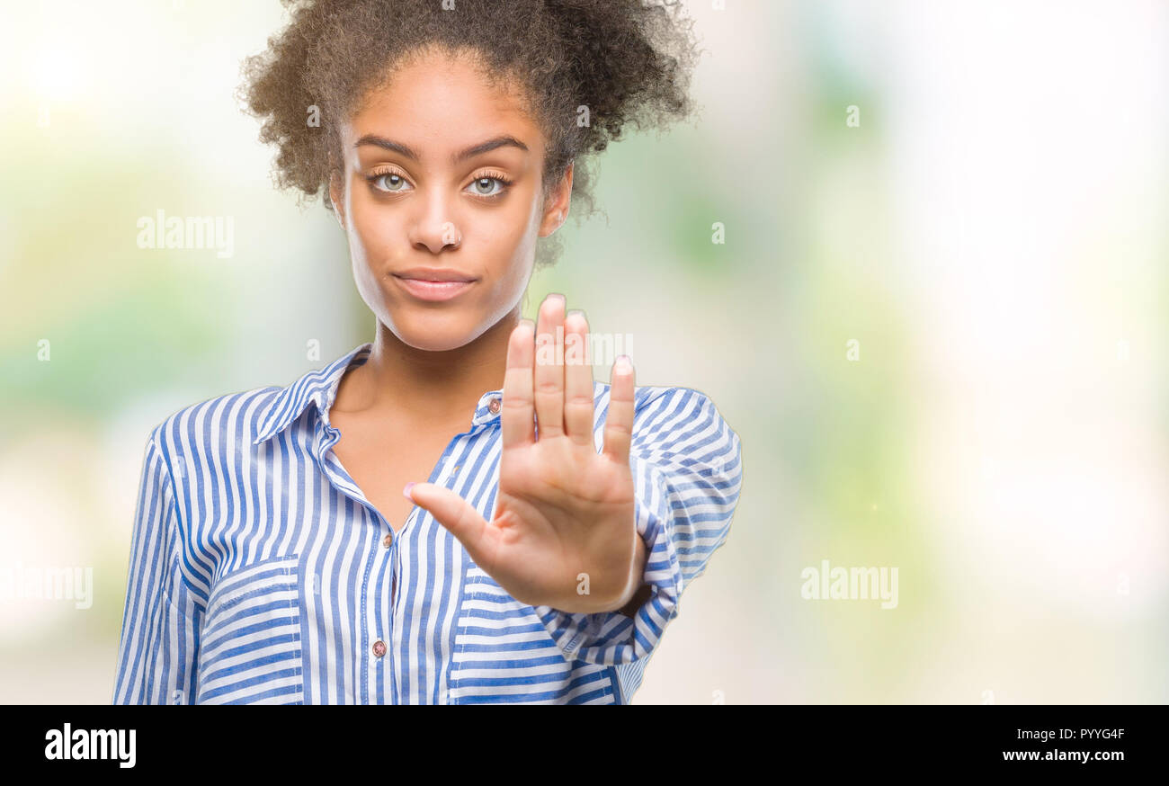 Young afro american woman over isolated background doing stop sing with ...