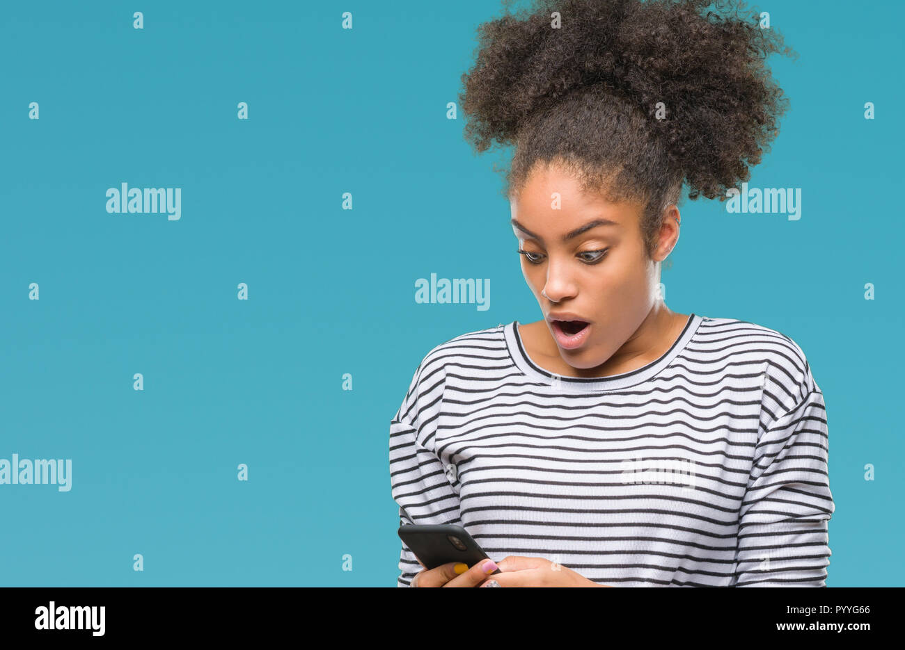 Young afro american woman texting using smartphone over isolated ...