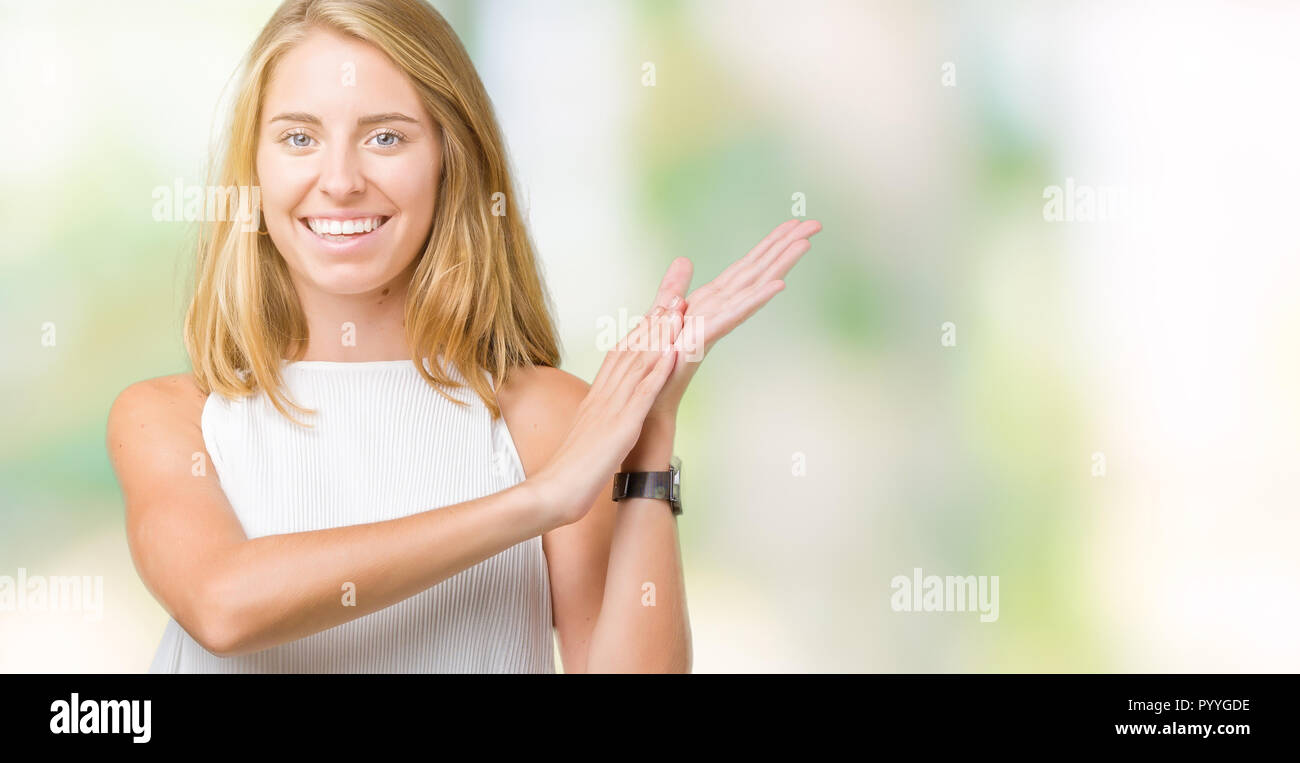 Beautiful young elegant woman over isolated background Clapping and ...