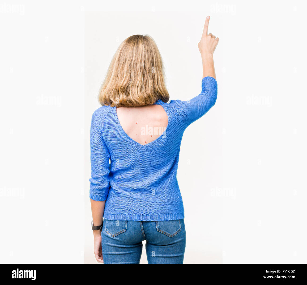 Beautiful young woman wearing blue sweater over isolated background ...