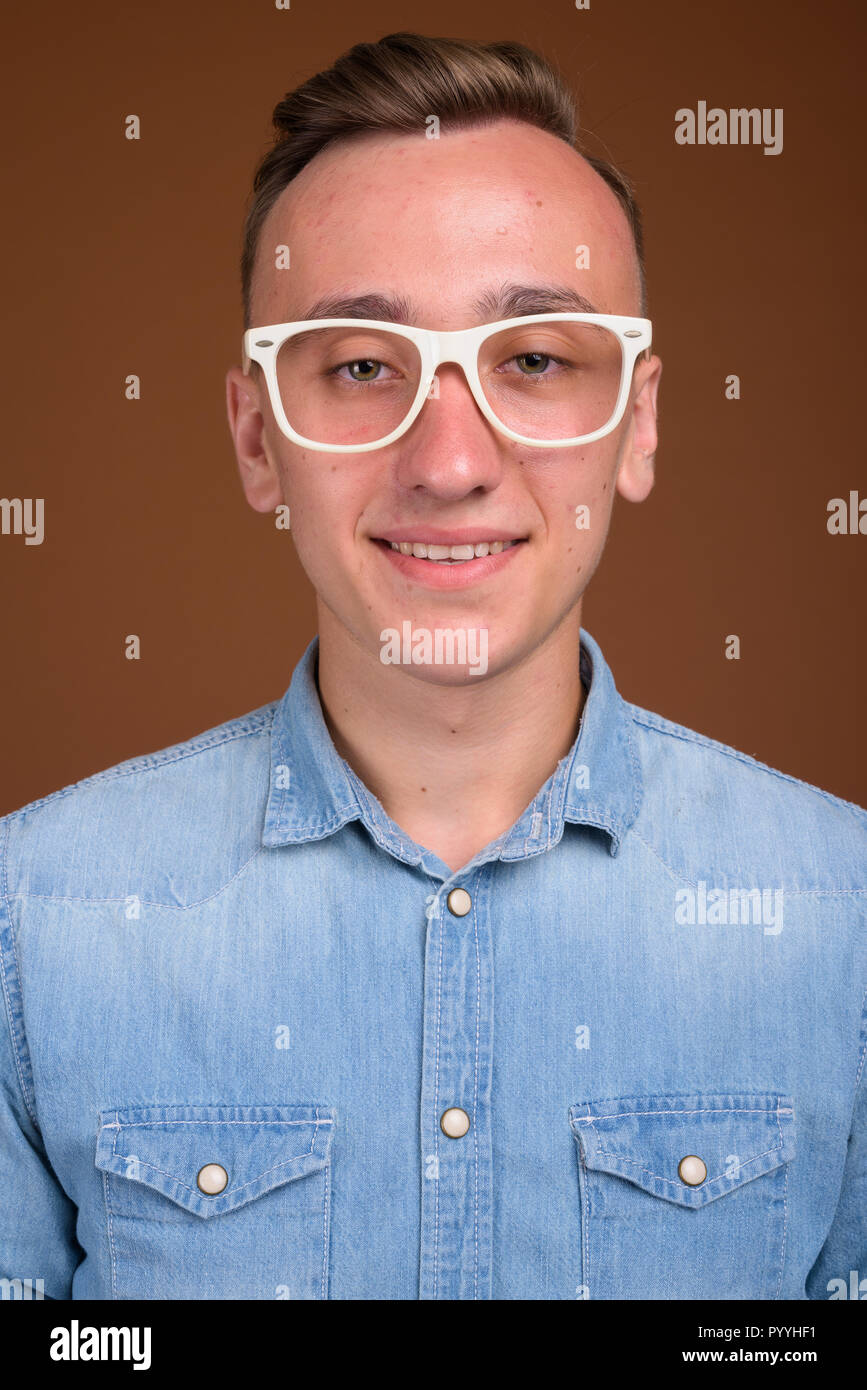 Face of young nerd man with blond hair and eyeglasses Stock Photo - Alamy
