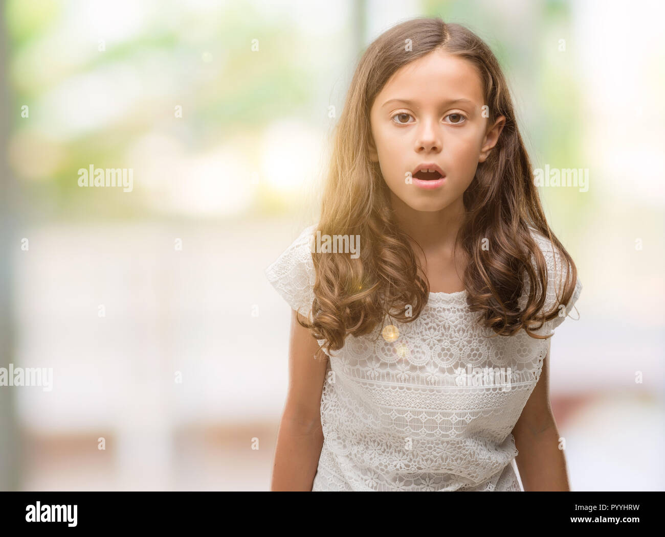 Brunette hispanic girl afraid and shocked with surprise expression ...