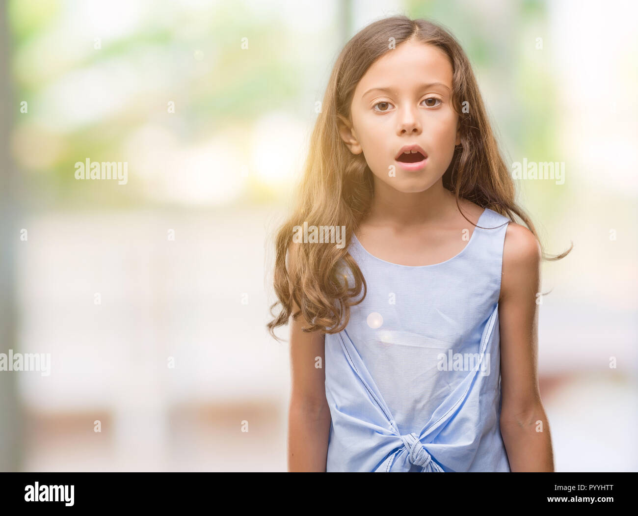 Brunette hispanic girl afraid and shocked with surprise expression ...